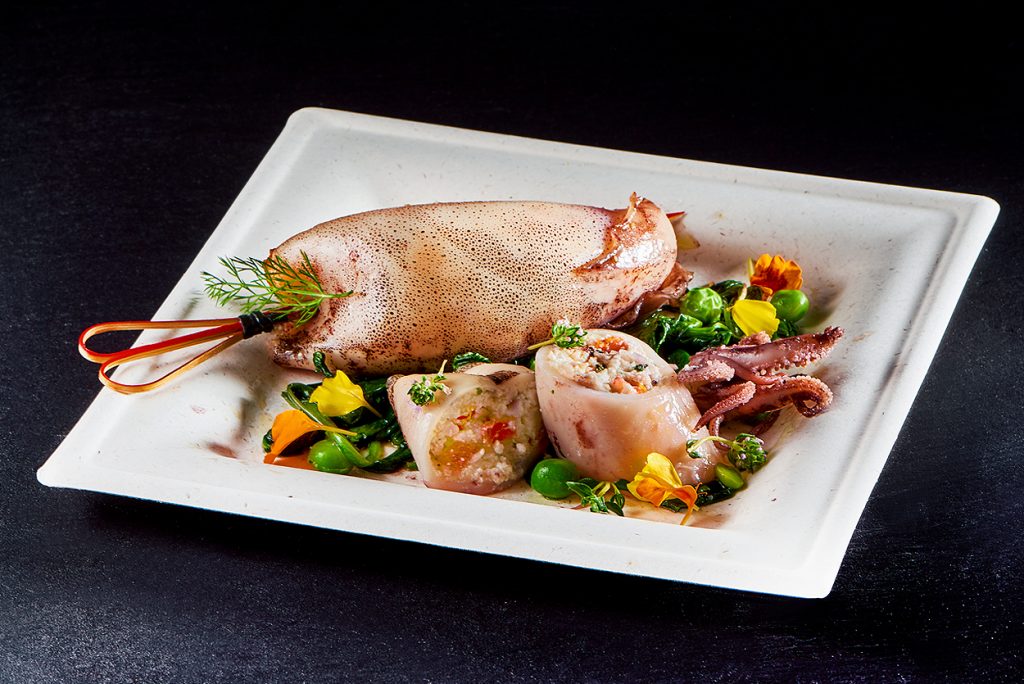 Squid stuffed with ricotta cheese on a bed of spinach and peas ...